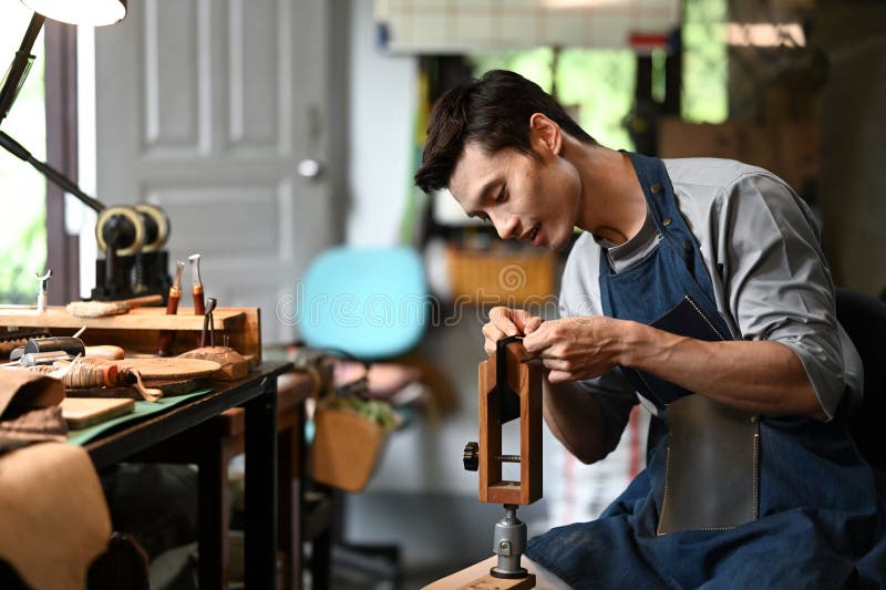 Skilled Craftsman in Apron Sewing while Making Handmade Leather Wallet ...