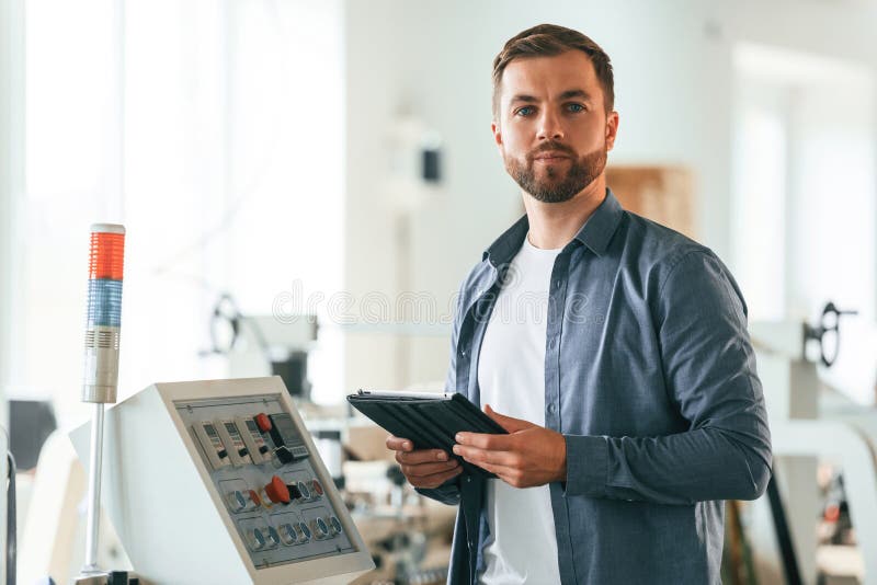 Skilled Engineer. Handsome Man is Working at the Factory of Creating ...