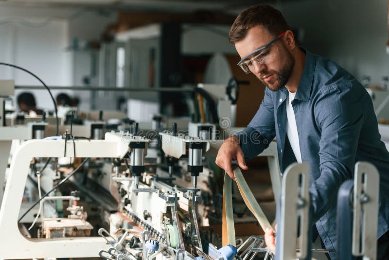 Skilled Engineer. Handsome Man is Working at the Factory of Creating ...