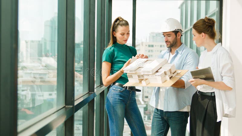 Engineer Holds House Model and Explain about House Construction ...