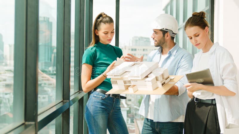 Engineer Holds House Model and Explain about House Construction ...