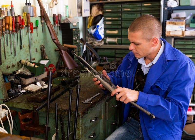 Workplace of Gunsmith in Weapons Workshop with Tools and Disassembled ...