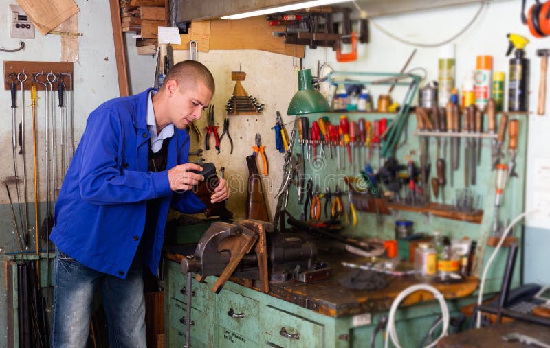 Gunsmith Assembling Shotgun after Diagnostics and Repair in Weapons ...