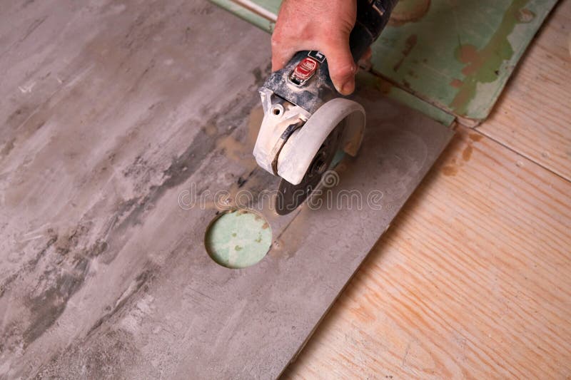 Skilled Hands Cut Granite Tiles during Repair Work in a Home Workshop ...