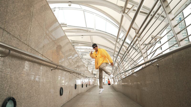 Skilled Happy Asian Hipster Walking while Dancing in Narrow Corridor ...