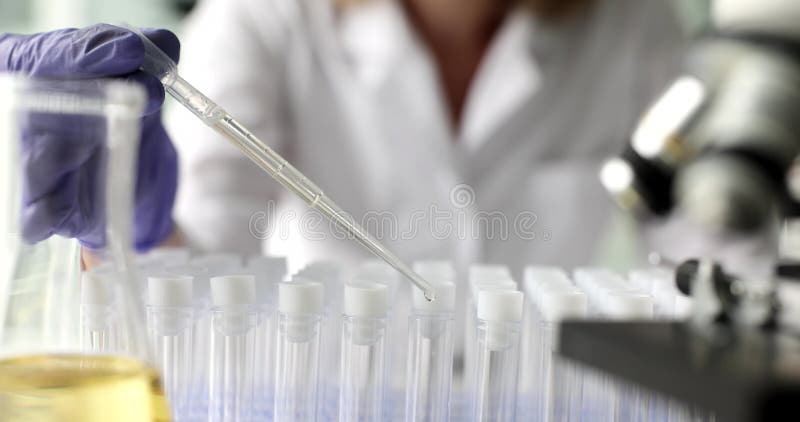 A Scientist is Using a Pipette in a Laboratory Setting To Conduct ...