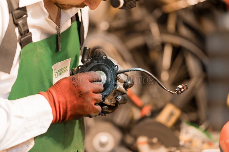 Skilled Mechanic Performing Precision Work on Engine Component in ...
