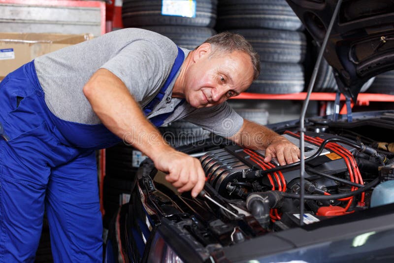 Mechanic repairing car stock image. Image of industrial - 265054577