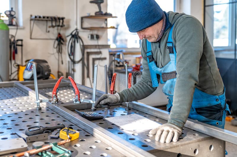 Welder Using Clamps and Measuring Tools on Metal Workbench Stock Image ...