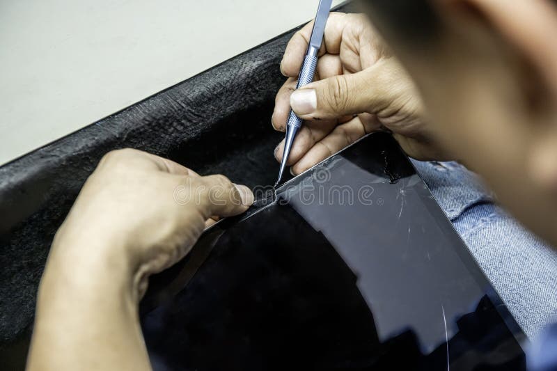 A Skilled Operator Disassembling the Broken Screen of a Tablet To ...