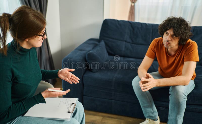 A Skilled Psychotherapis Talking To Patient at Therapy Session Stock ...
