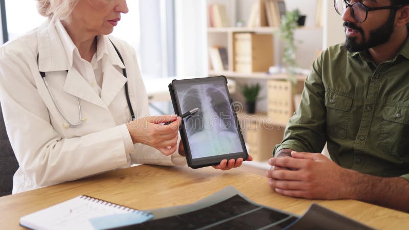 Skilled Radiologist in White Uniform Explaining Visible Changes on X ...