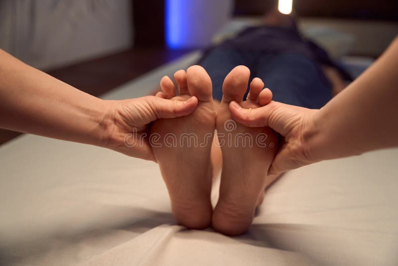Skilled Reflexologist Stimulating Acupressure Points on Female Patient ...