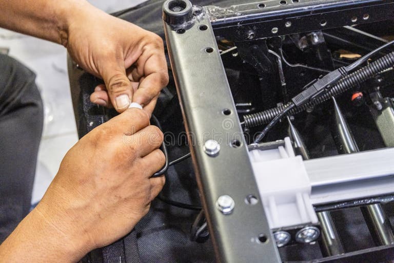 A Skilled Technician Assembling and Checking the Electrical System and ...