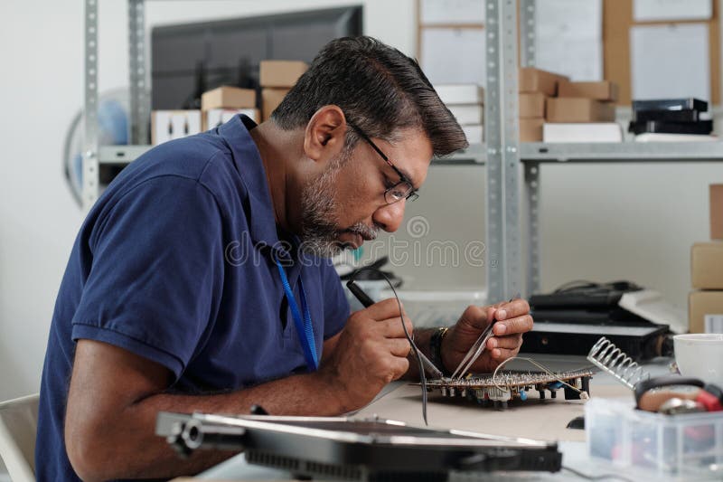 Skilled Technician Repairing Electronic Device in Workshop Stock Image ...
