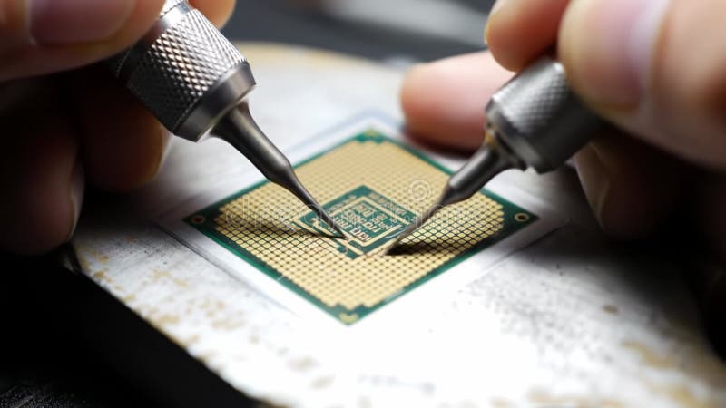 Expert Hands Carefully Inspect a Computer Chip with Precision Tools for ...