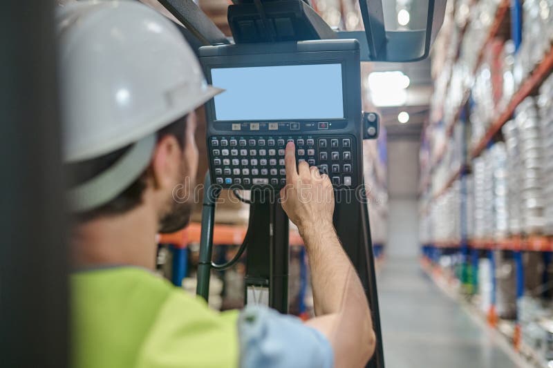 Skilled Warehouse Worker Operating the Electric Forklift Stock Photo ...