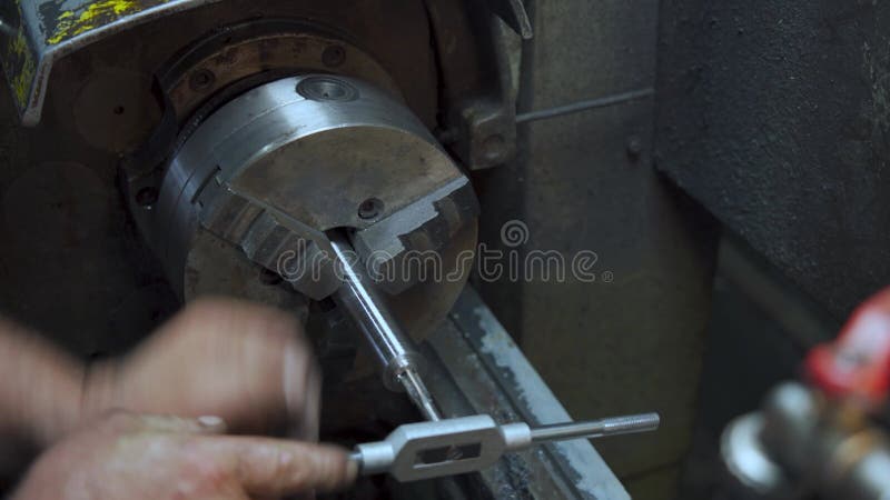 Experienced Machinist Manually Threading Metal Part on a Lathe Machine ...