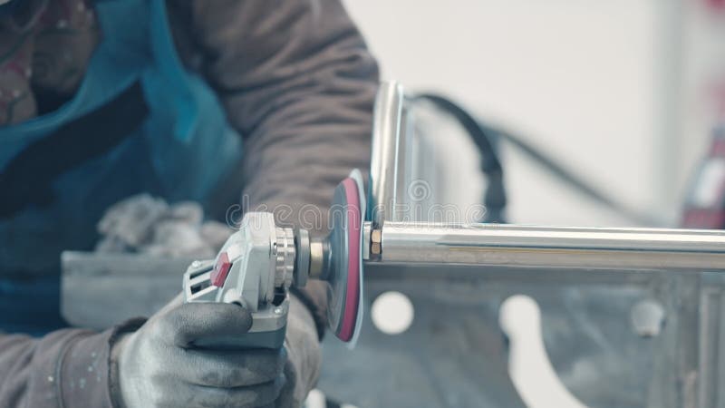 Worker Grinding Metal with Safety Equipment in Industrial Workshop ...