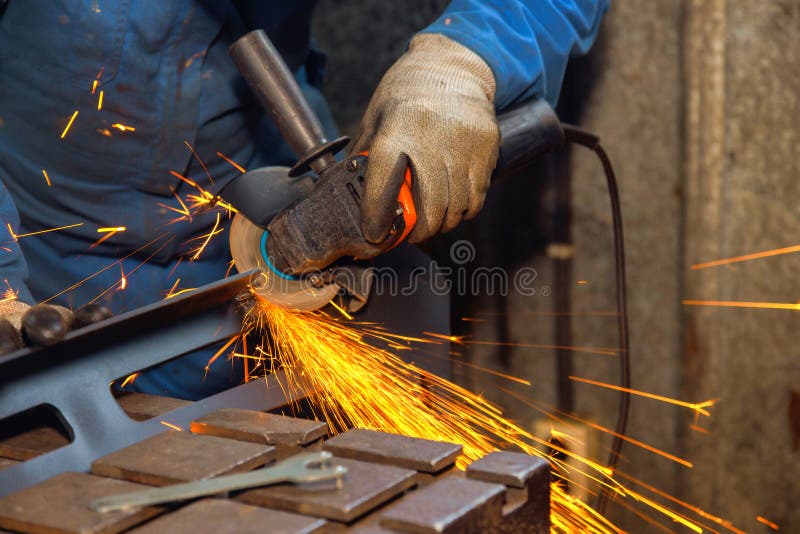 Skilled Worker Grinding Metal in Workshop, Creating Sparks during ...