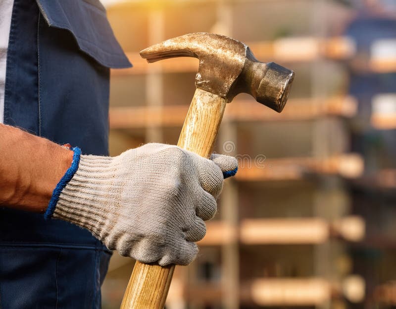 Skilled Worker Holding Hammer Ready for Construction Task at Building ...