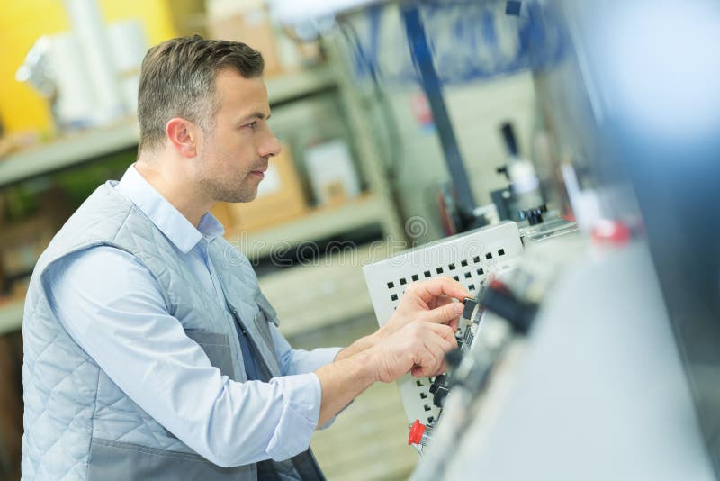 Skilled Worker Operating Manufacturing Machine Stock Image - Image of ...