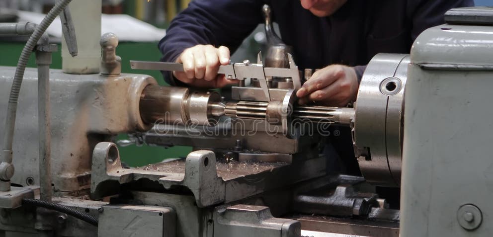 Skilled Worker Precision Measuring Metal Component in Industrial Workshop during Daytime Stock ...