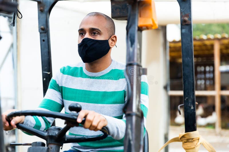 Skilled Worker in Protective Mask of Materials Warehouse Working on ...