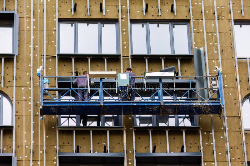 Skilled Workers Installing Windows on a High-Rise Building Stock Photo ...