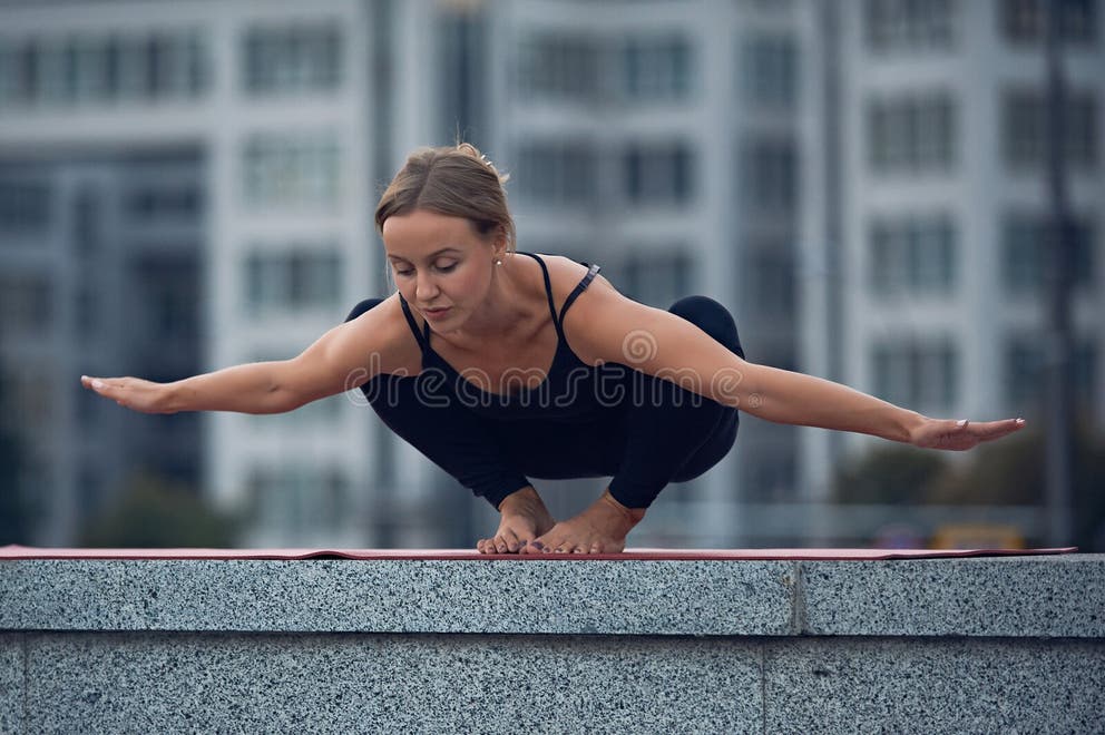 Yoga Practitioner Performs an Impressive Pose on a City Rooftop during ...