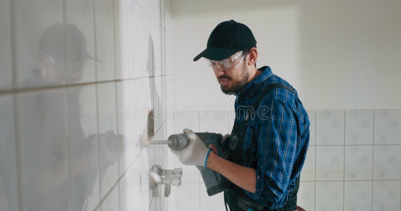 Skilled Young Builder in Blue Overalls Working with Pneumatic Chisel ...
