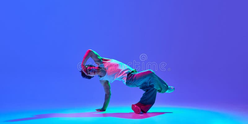 Skilled Young Dancer Performing Breathtaking Breakdance Tricks with ...