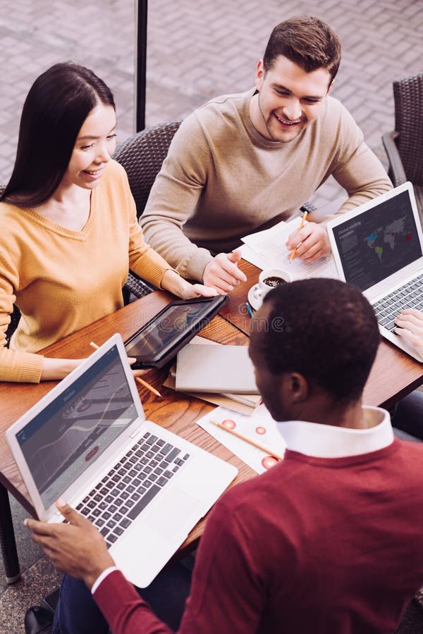 Skillful Ambitious Colleagues Using Technology for Working Stock Photo ...