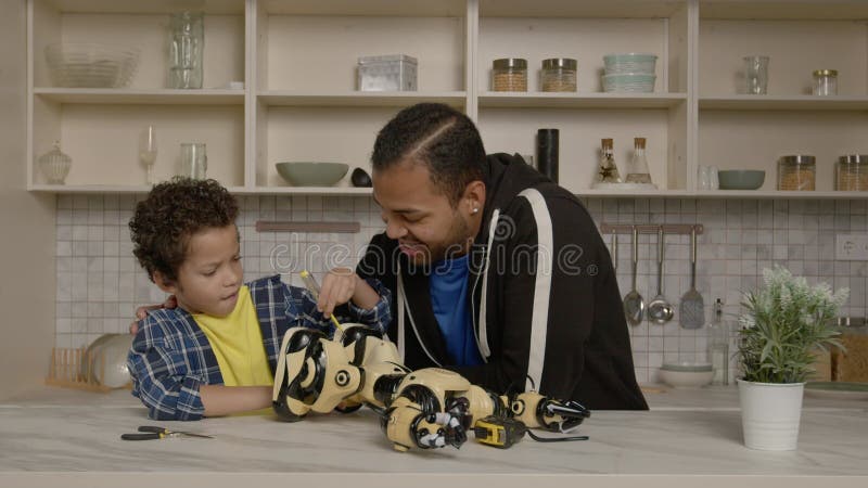 Skillful Preadolescent Black Son with Help of Dad Fixing Broken Toy ...