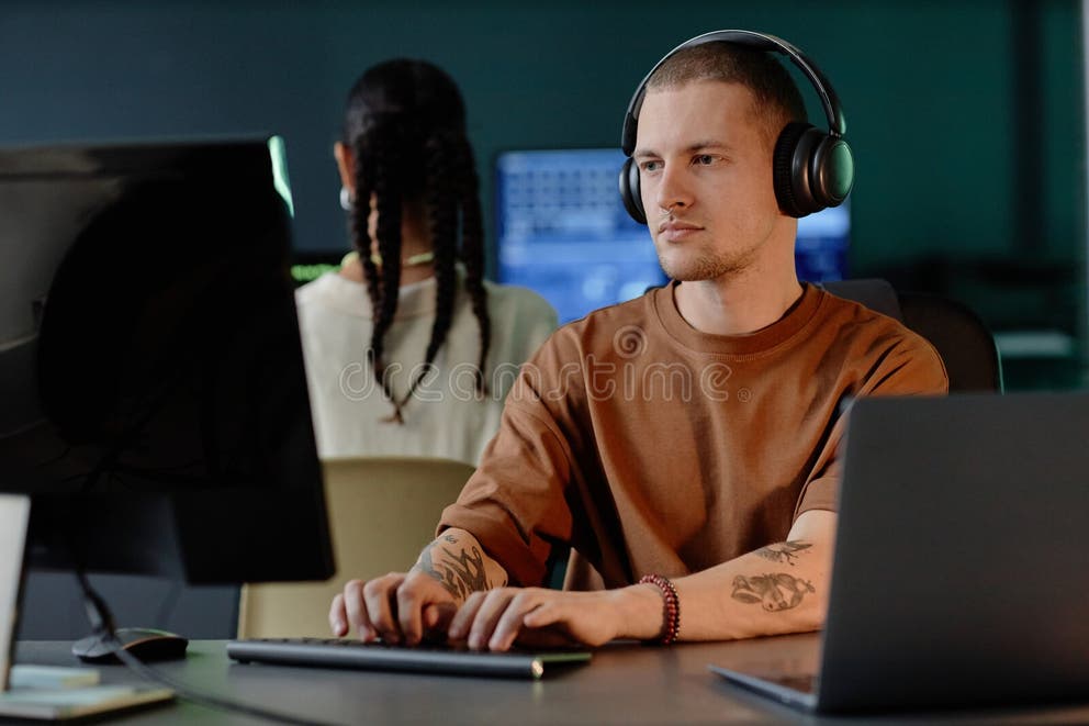 Skillful it Developer in Headphones Typing on Computer Keyboard Working ...
