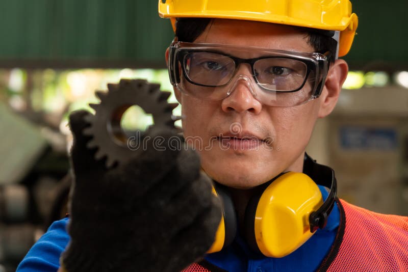 Skillful Factory Worker Looking at Machine Part in Workshop Stock Photo ...