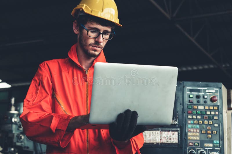 Skillful Factory Worker Working with Laptop Computer To Do Procedure ...