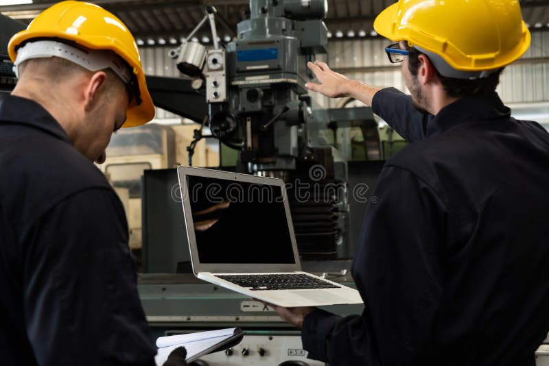 Skillful Factory Worker Working with Laptop Computer To Do Procedure ...