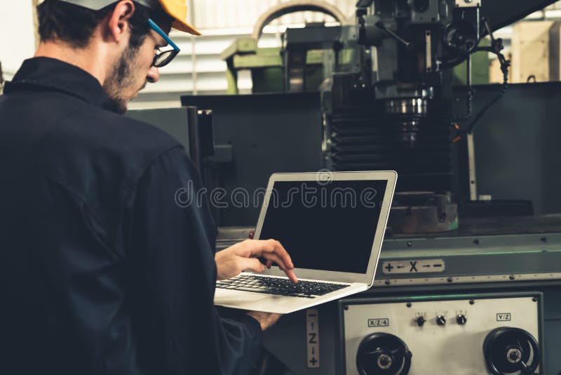 Skillful Factory Worker Working with Laptop Computer To Do Procedure ...