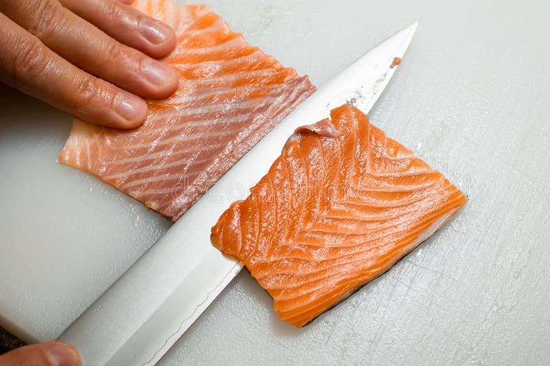 Skillfull Chef Masterfully Cuts Fresh Salmon Fillet with Sharp Knife on ...
