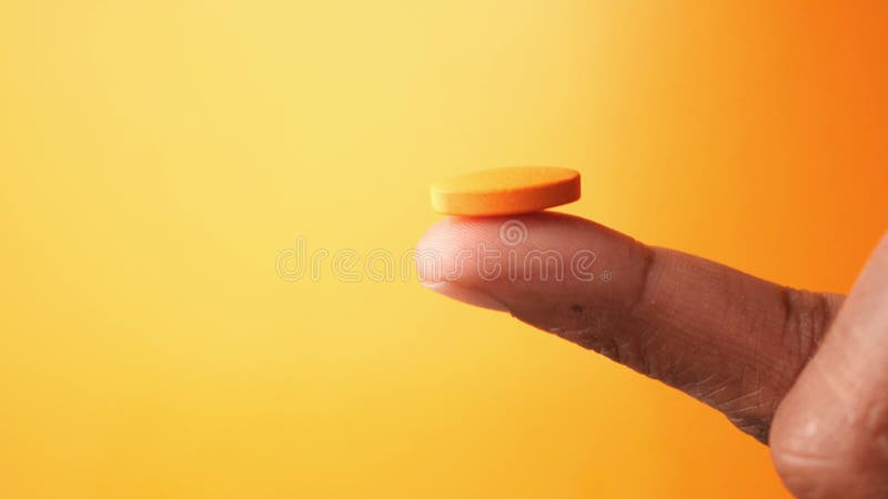 Skillfully Balancing a Vibrant Orange Token on a Single Finger with ...