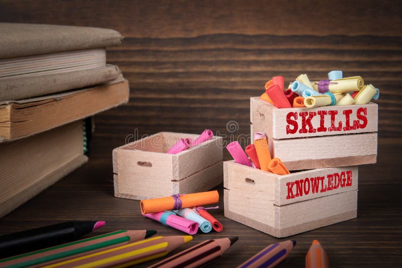 SKILLS and KNOWLEDGE Concept. Colored Papr Scrolls in Wooden Boxes on ...