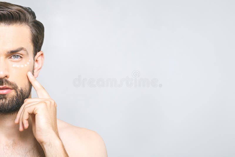 Skin Care Handsome Happy Young Shirtless Man Applying Cream At His