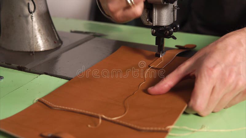 Skinner is Making Stitch on a Leather Bag Using Industrial Sewing ...