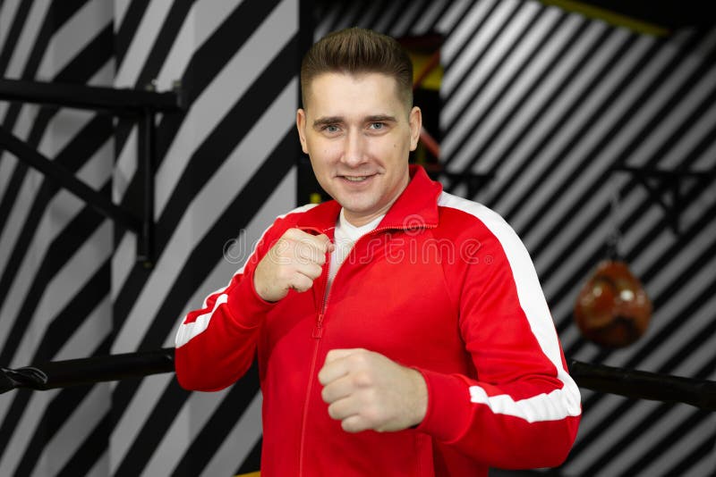 Skinny Man in a Red Tracksuit Poses and Has Fun in the Boxing Ring ...