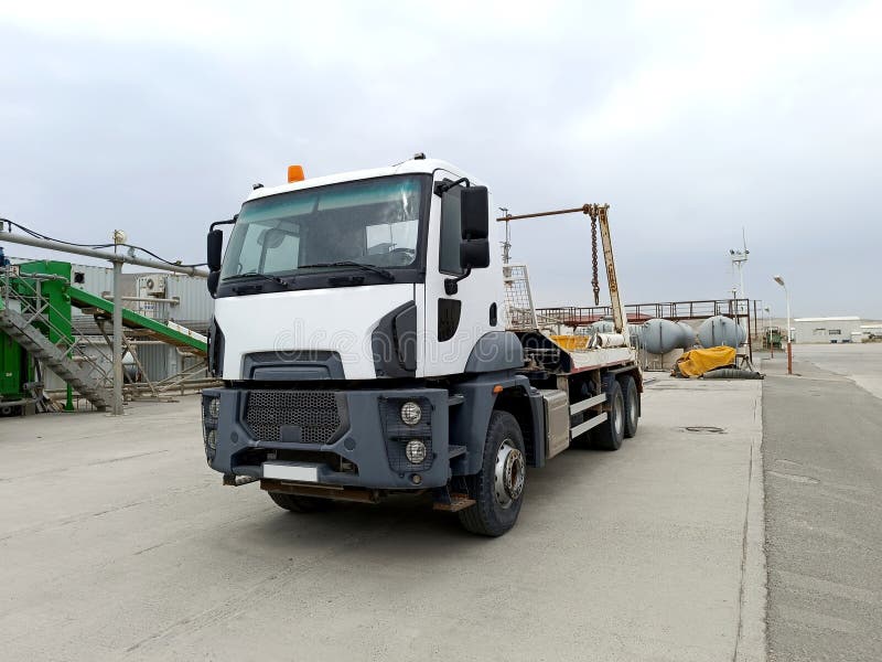 Skip Loader on the Factory Premises. Skip Truck Surrounded by ...