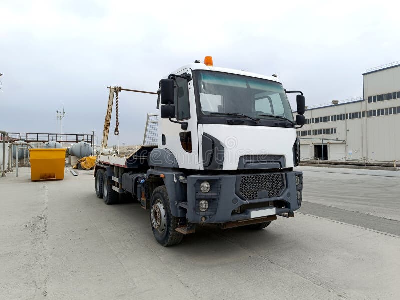 Skip Loader on the Factory Premises. Skip Truck Surrounded by ...