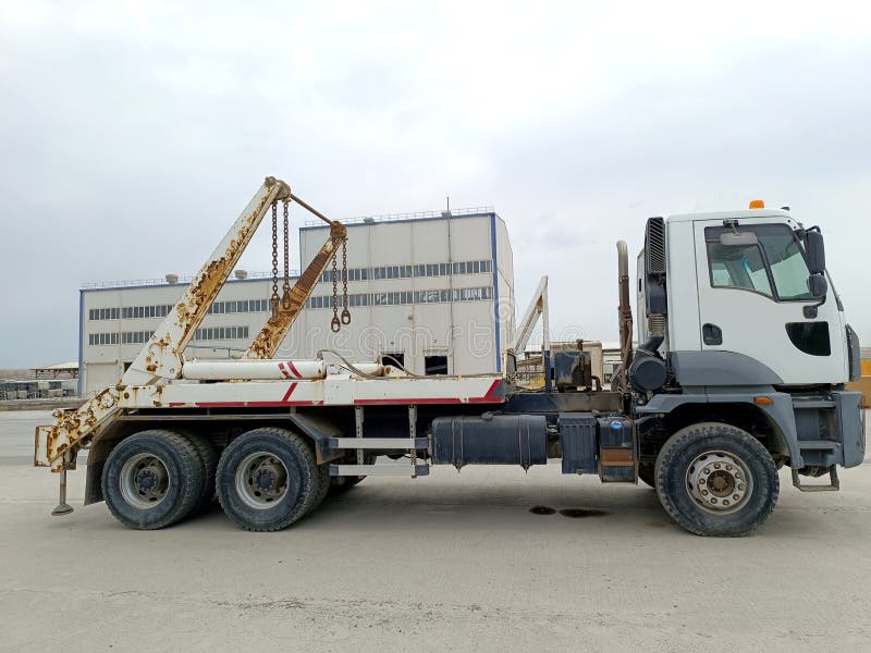 Skip Loader on the Factory Premises. Skip Truck Surrounded by ...