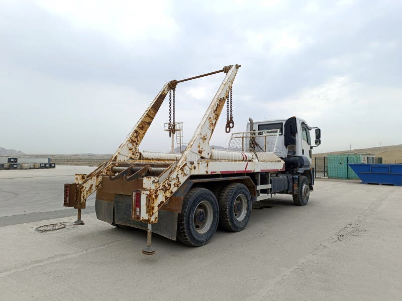 Skip Loader on the Factory Premises. Skip Truck Surrounded by ...