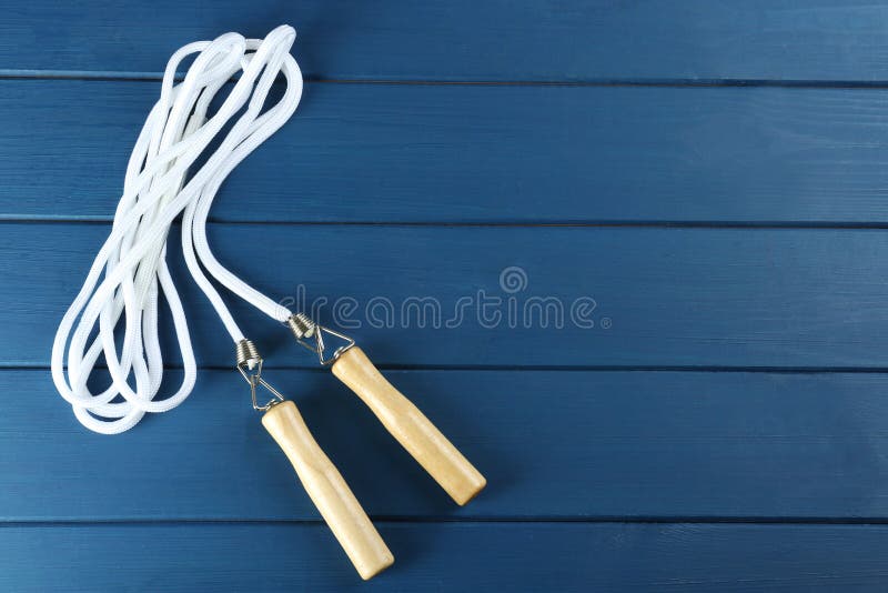 Skipping Rope on Blue Wooden Table, Top View. Space for Text Stock ...